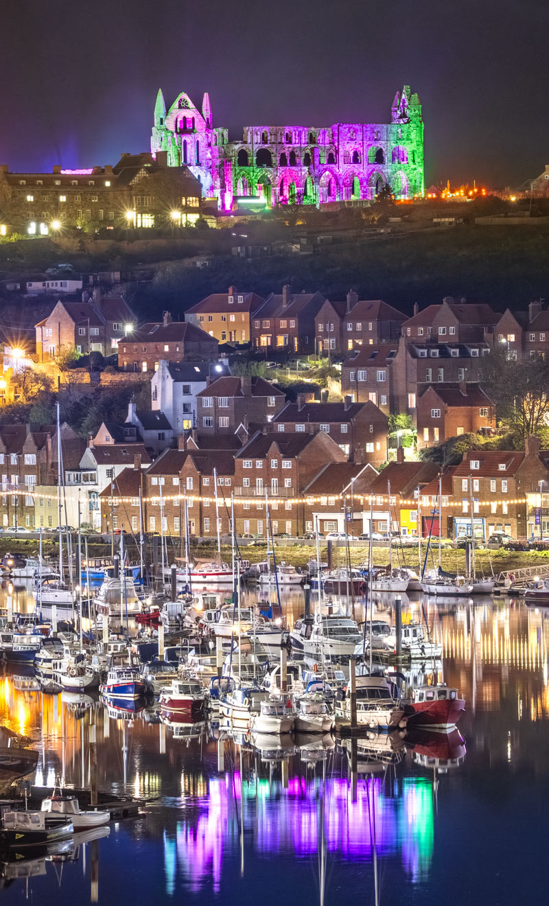 Illuminated Abbey Green And Purple Reflections Over The Whitby River ...